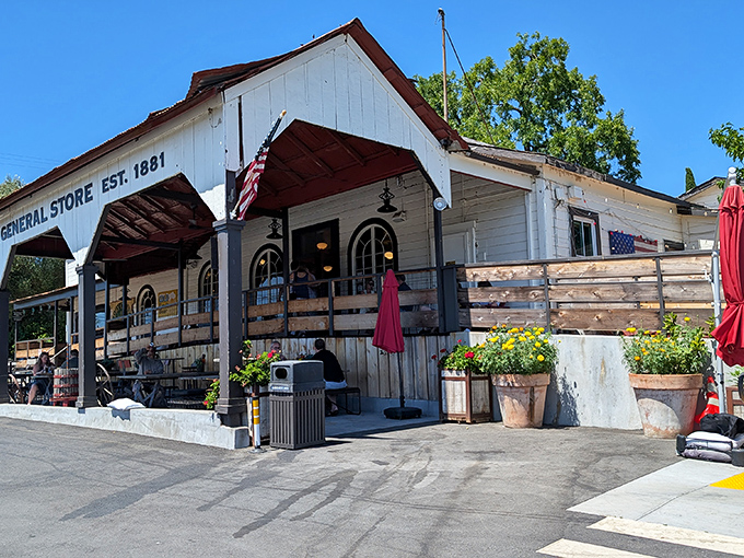 The white clapboard façade of Dry Creek General Store stands like a time capsule in Healdsburg, complete with "THE BAR" sign that promises good times ahead.