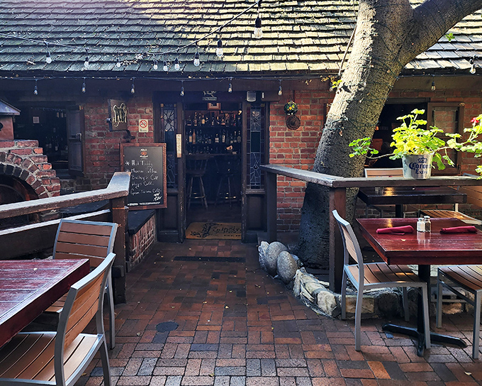 The rustic wooden exterior of Hog's Breath Inn beckons like an old friend, its distinctive sign promising comfort and satisfaction in charming Carmel-By-The-Sea.