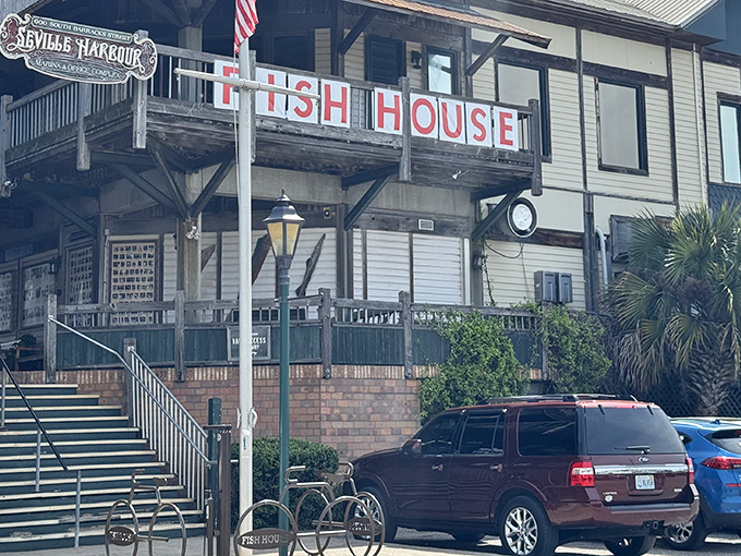 The weathered wooden exterior of The Fish House stands like a sentry over Pensacola Bay, promising seafood treasures within those unassuming walls.
