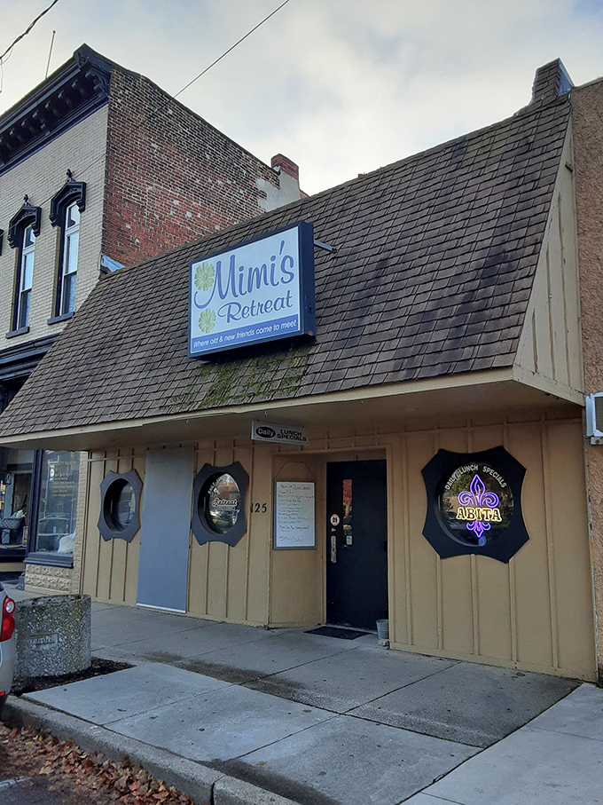 The unassuming exterior of Mimi's Retreat proves once again that culinary treasures often hide behind modest facades. Those porthole windows hint at nautical charm inside.