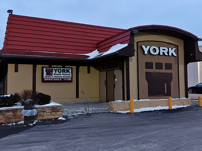 The iconic red-roofed York Steak House stands like a culinary time capsule in Columbus, beckoning hungry patrons with its nostalgic charm and promise of sizzling steaks.