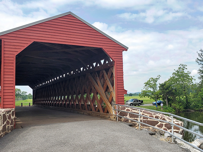 A classic American motorcycle stands sentinel at the entrance to this crimson time capsule, where history and horsepower create perfect harmony.