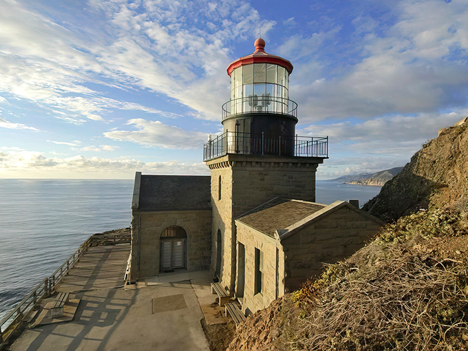 The iconic red-topped lighthouse stands defiantly against the Pacific, like California's version of a medieval castle with better ocean views.