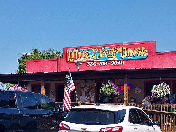 The little red diner that could! Little Creek's welcoming wooden porch and bright exterior beckon hungry travelers like a culinary lighthouse in Germanton.