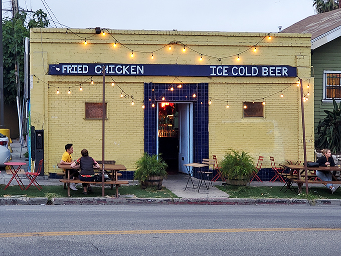 The yellow brick building with its straightforward "FRIED CHICKEN" and "ICE COLD BEER" sign is like a culinary lighthouse guiding hungry souls to salvation.