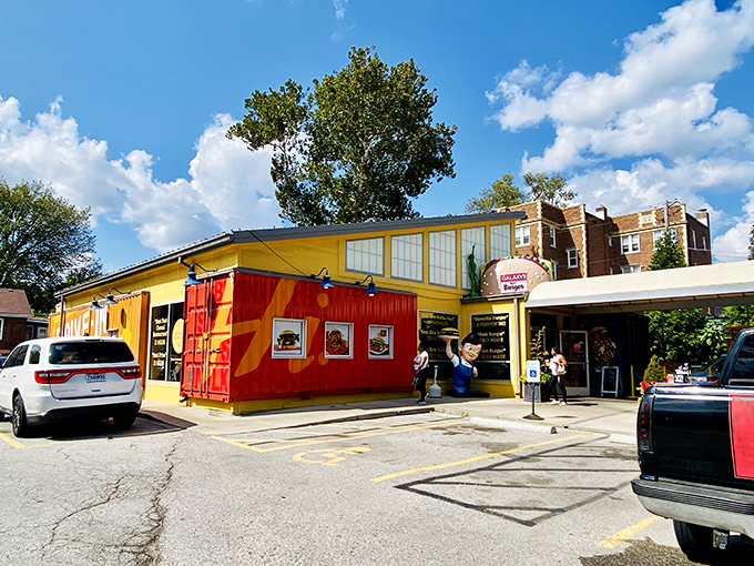 The bright yellow shipping container exterior of Hi-Pointe Drive-In stands out like a culinary beacon, promising quality food with industrial-chic flair.