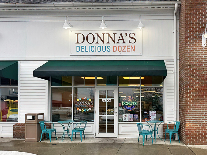 The iconic green awning and crisp white facade of Donna's Delicious Dozen welcomes donut pilgrims like a beacon of sugary salvation in Columbus.