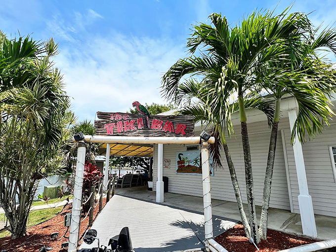 Paradise found! Scotty's Tiki Bar welcomes you with swaying palms and a sign that practically whispers, "Your vacation starts now."