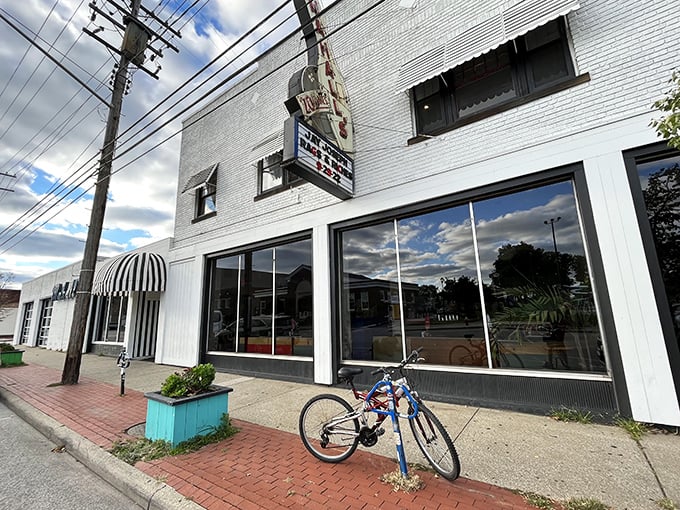 The white-brick facade of Mahall's stands like a time capsule on Madison Avenue, complete with vintage signage and that classic striped awning that screams "good times inside."