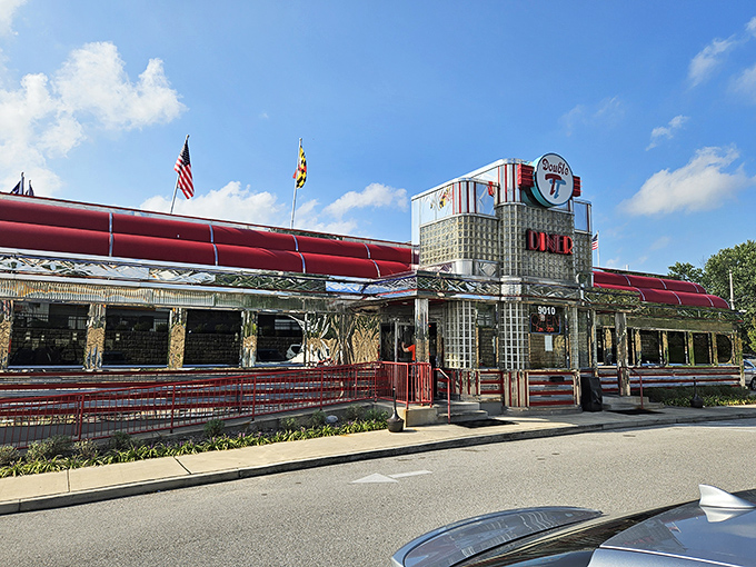 The gleaming chrome exterior of Double T Diner stands like a time machine on wheels, Maryland flags waving a welcome to hungry travelers.