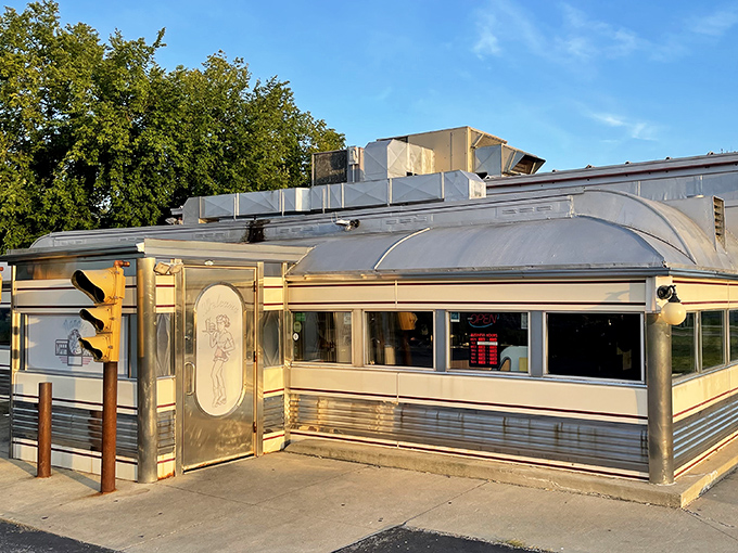 The gleaming stainless steel exterior of Nancy's Main Street Diner stands like a time capsule on Grafton's Main Street, beckoning hungry travelers with promises of comfort food perfection.
