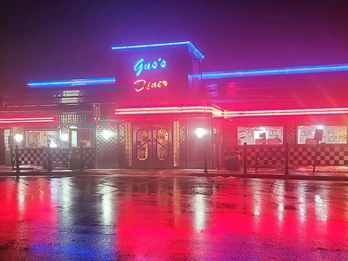 The gleaming stainless steel exterior of Gus's Diner stands like a time capsule from the 1950s, complete with checkered trim and an American flag proudly waving above.