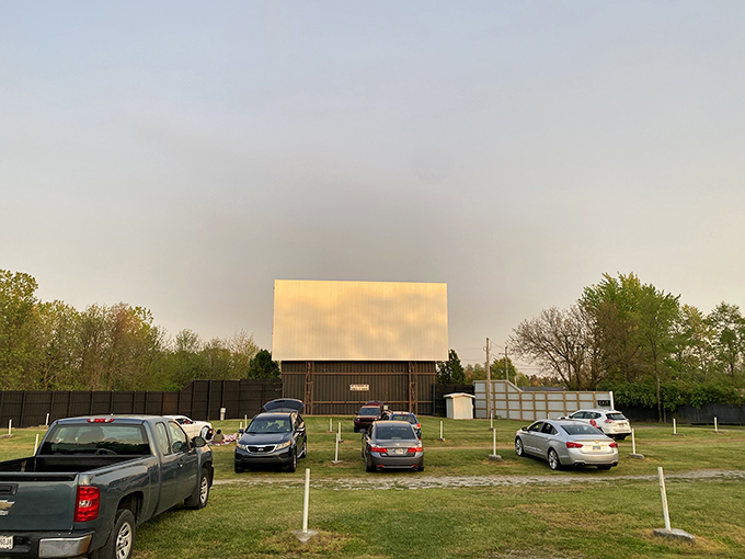 Cars lined up under the open sky, waiting for dusk to transform an ordinary field into cinema magic. Some traditions just feel right.