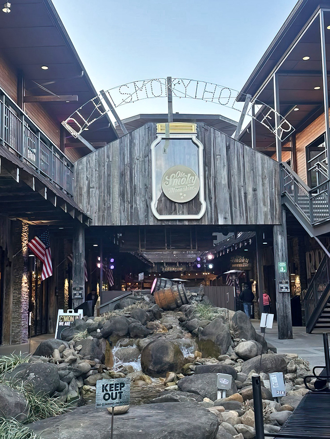 Welcome to moonshine paradise! The rustic wooden facade of Ole Smoky's "The Holler" invites visitors into a world where mountain traditions flow as freely as their spirits.