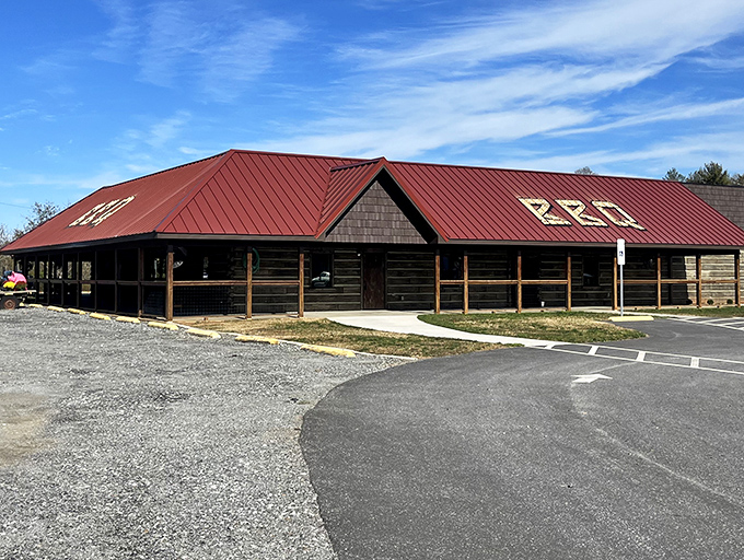 The rustic log cabin exterior with its bright red roof isn't trying to impress anyone&mdash;it's saving all that energy for what's smoking inside.