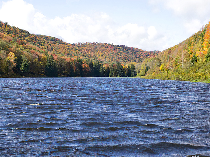 The serene waters of Lyman Lake stretch between colorful hills, offering a tranquil escape that feels like nature's version of a private resort.