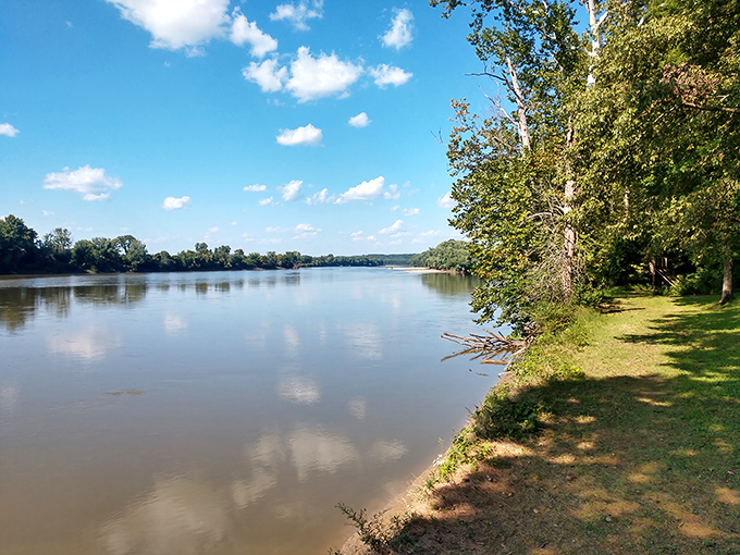 The Wabash River flows lazily past Harmonie State Park, reflecting clouds like nature's own Instagram filter. Pure Indiana serenity.