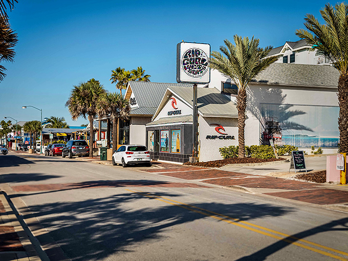 Palm trees frame this surf shop corner like nature's welcome committee. Edgewater's retail scene blends coastal cool with small-town charm.
