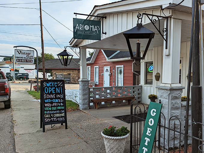 The charming exterior of Ari & Mia's beckons with its vintage lanterns and welcoming "GOETTA" sign&mdash;a true Ohio small-town treasure.