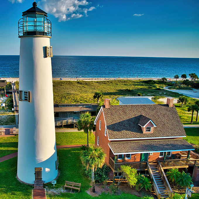 The Cape St. George Lighthouse stands sentinel over sugar-white beaches, a postcard-perfect reminder that some Florida treasures remain blissfully uncommercialized.