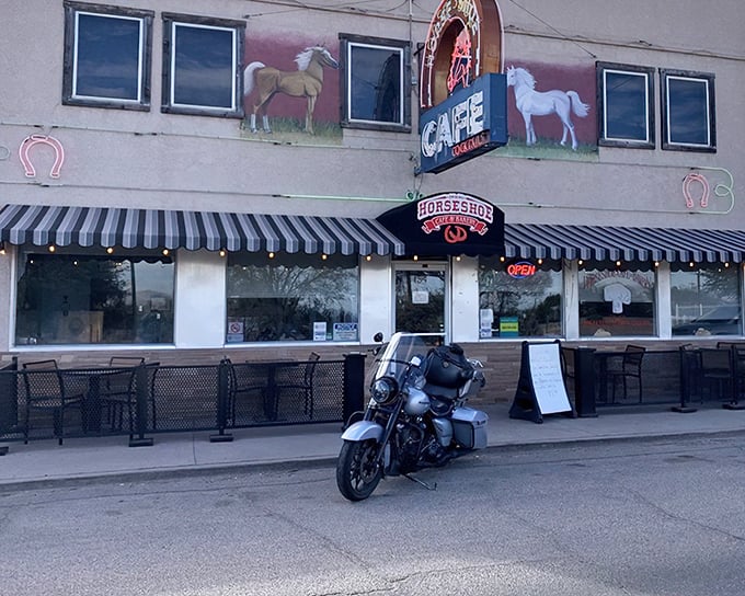 The iconic facade of The Horseshoe welcomes hungry travelers with its charming horse paintings and classic black-and-white striped awning&mdash;a beacon of comfort food in Benson.