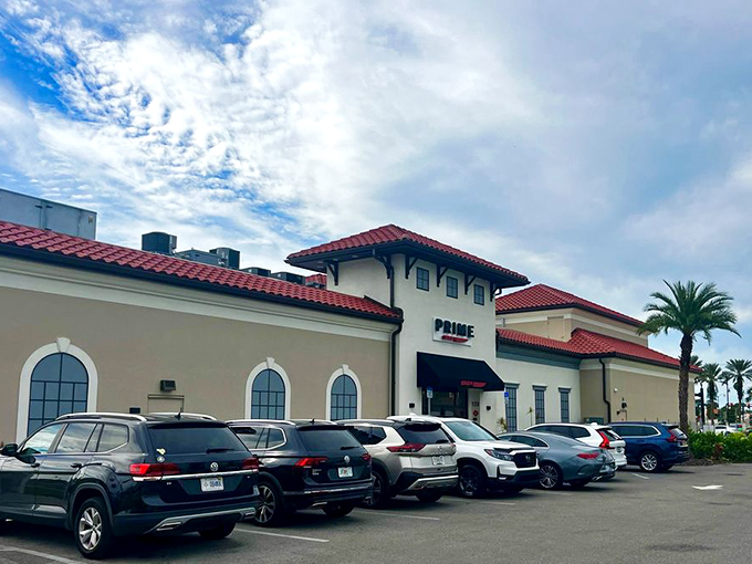 The Mediterranean-inspired exterior of PRIME stands proudly against Florida's blue sky, its red-tiled roof and cream walls promising culinary adventures within.