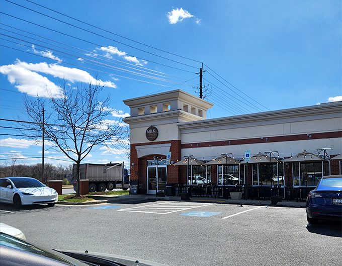 The welcoming brick facade of Milk & Honey beckons like a southern grandmother with fresh biscuits cooling on the windowsill. Those benches outside? They're not just decoration.