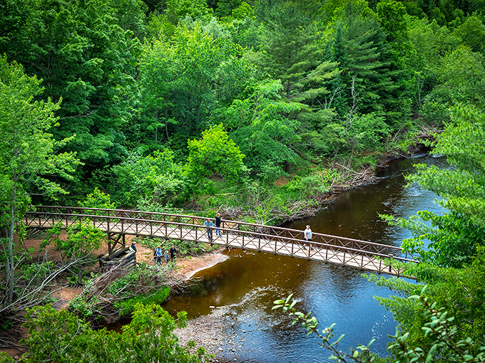 Nature's own watercolor masterpiece &ndash; autumn foliage frames the rushing copper-tinted waters as they tumble over ancient volcanic rock.