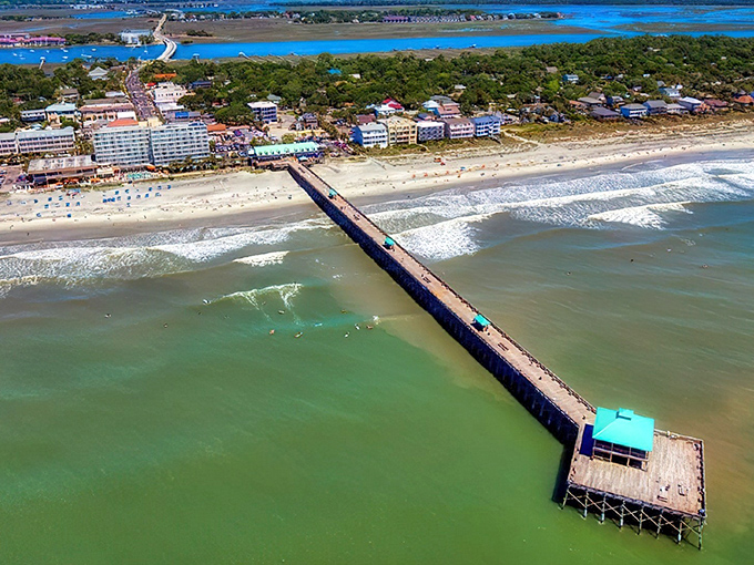 The iconic Folly Beach Pier stretches into the Atlantic like nature's welcome mat. From above, you can see why locals call this slice of paradise "The Edge of America."