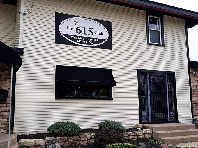 The cream-colored exterior with stone accents and black awnings whispers "classic Wisconsin supper club" without shouting. Culinary treasures await behind that unassuming fa&ccedil;ade.