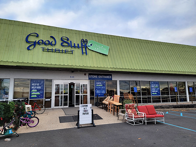 The iconic green roof and blue signage of Good Stuff Thrift beckons bargain hunters like a lighthouse guiding ships to treasure-filled shores.