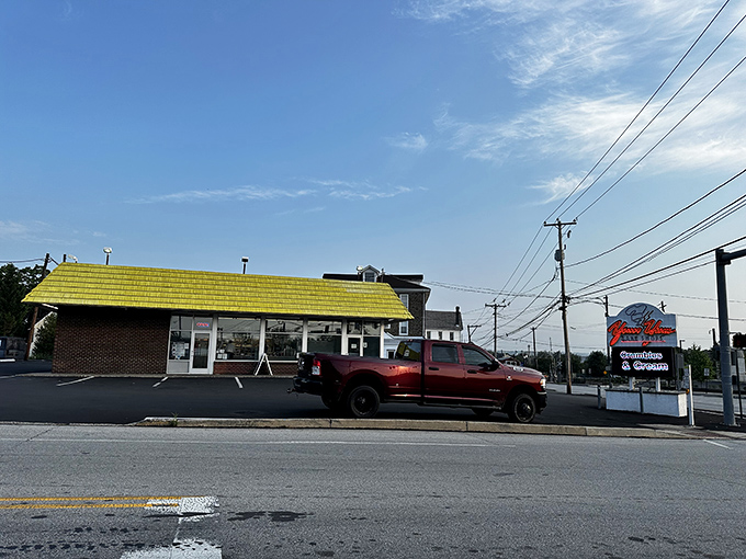 The sunshine-yellow roof of Yum Yum Bake Shops isn't just eye-catching—it's nature's way of saying "happiness served here daily."