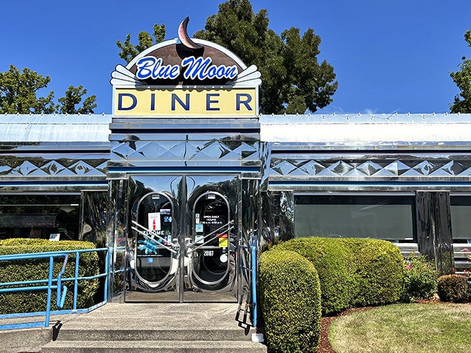 The gleaming chrome exterior of Blue Moon Diner shines like a beacon of breakfast hope, complete with that iconic blue crescent moon sign calling hungry Oregonians home.