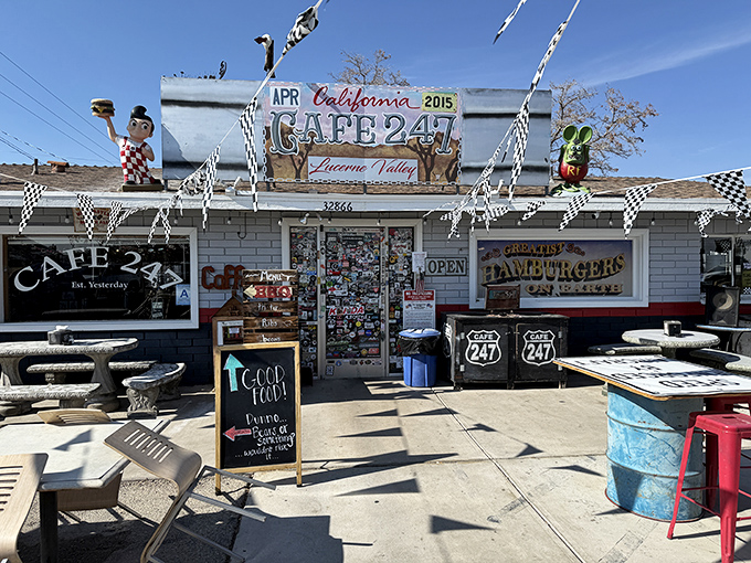 The desert sun illuminates this roadside treasure like a mirage, complete with checkered flags and quirky decor that screams "pull over now!"