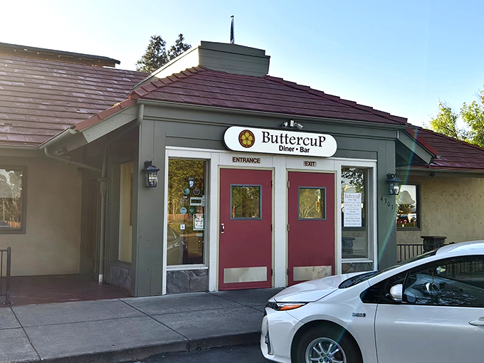 The charming exterior of Buttercup beckons with its burgundy doors and cozy stone accents&mdash;like a storybook cottage that happens to serve incredible eggs Benedict.