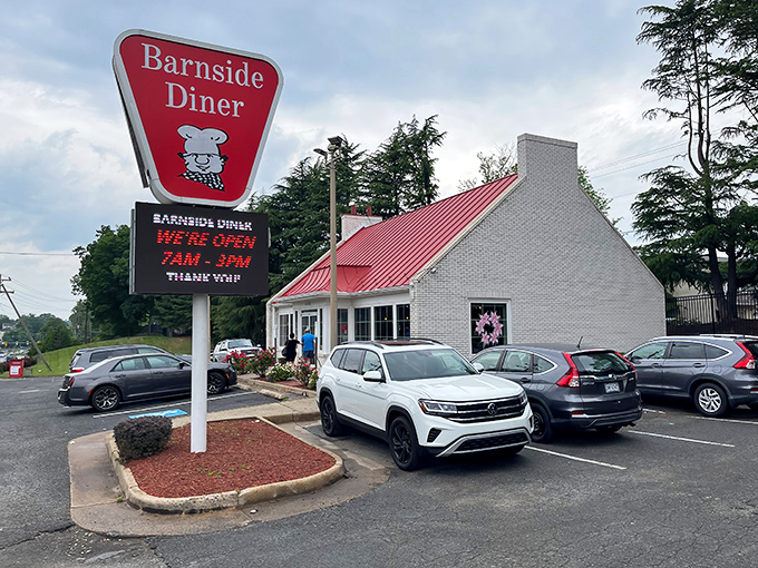 The iconic red-roofed Barnside Diner stands like a beacon of breakfast hope, promising culinary comfort beneath its cheerful chef sign. 