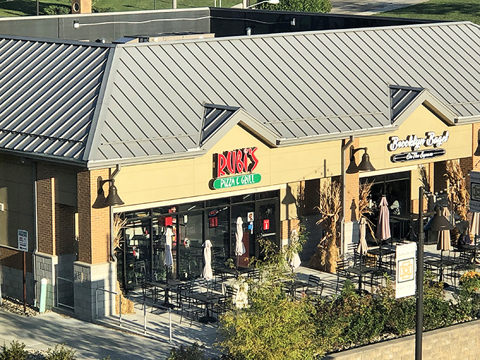 The neon glow of Rubi's sign beckons like a lighthouse for the pizza-starved, promising delicious refuge from ordinary dining experiences.