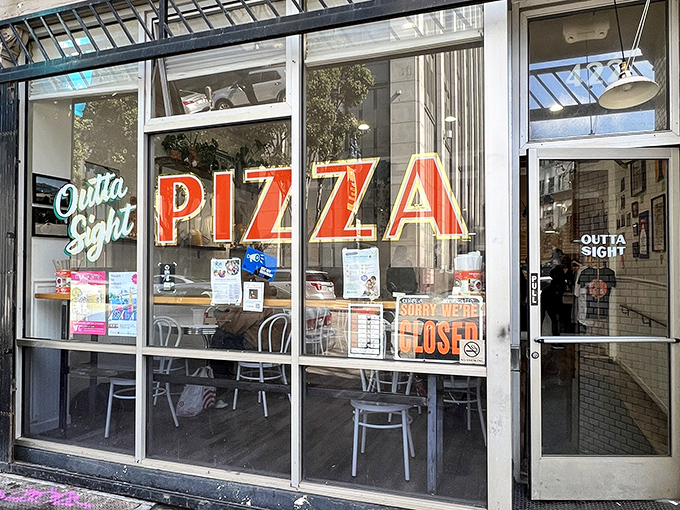 The neon promise of "Outta Sight Pizza" glows like a beacon for hungry San Franciscans. This unassuming storefront holds pizza treasures waiting to be discovered.