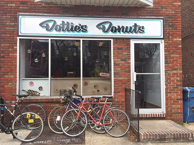 The unassuming brick storefront of Dottie's Donuts in West Philly – where vegan donut dreams come true without a hint of compromise.