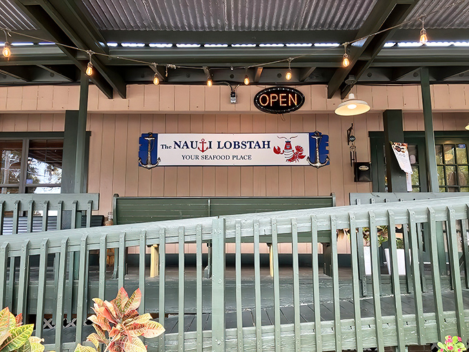 The coastal charm hits you before you even step inside. That mint-green fence and beachy sign promise New England vibes in the heart of Florida.