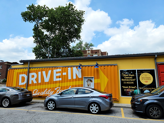 The bright yellow shipping container exterior of Hi-Pointe Drive-In stands out like a culinary beacon, promising quality food with industrial-chic flair.