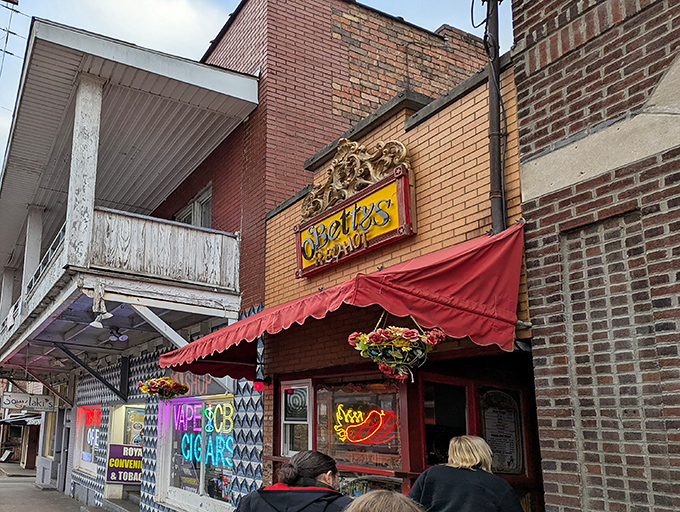 The unassuming storefront of O'Betty's Red Hot beckons with its vibrant red awning and quirky charm, like a secret clubhouse for hot dog aficionados.