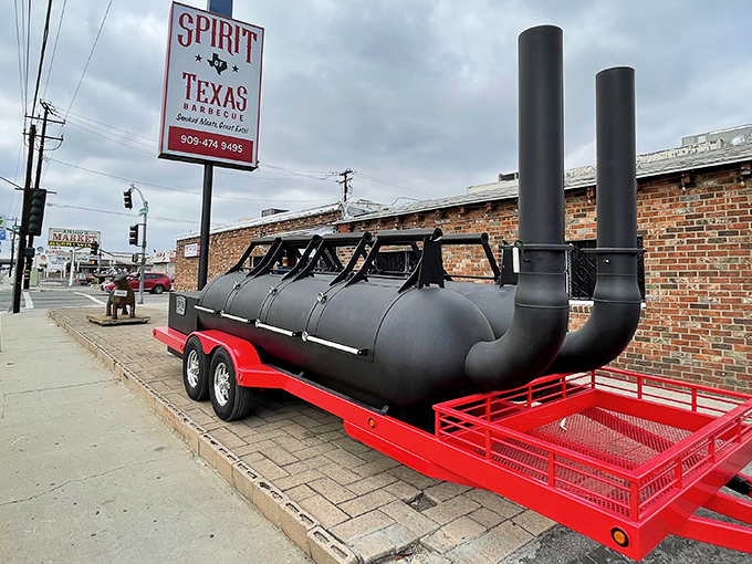 The unmistakable sign of serious barbecue: a custom smoker parked proudly outside, announcing to the world that slow-cooked magic happens here.