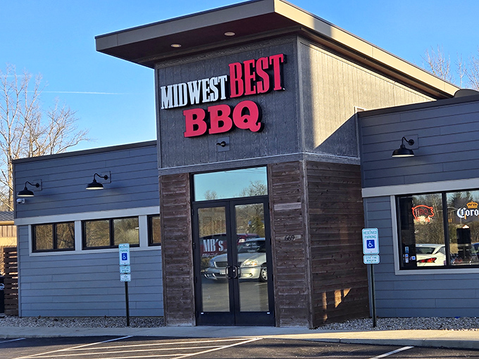 The modern rustic exterior of Midwest Best BBQ beckons like a beacon of smoky promise in Loveland. Those red letters might as well say "salvation" for hungry travelers.