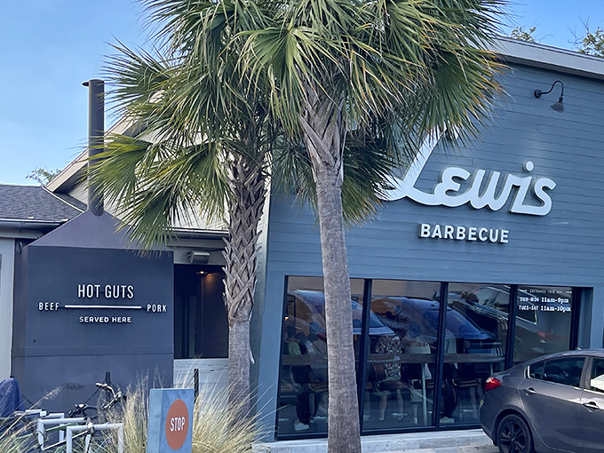 The blue exterior of Lewis Barbecue stands like a smoke-scented beacon in Charleston, with palm trees providing that perfect Southern frame for meat pilgrims.
