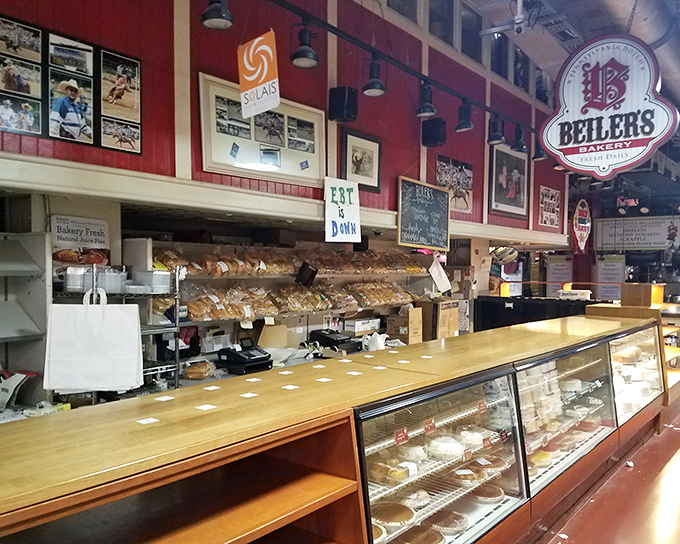 The iconic red walls and gleaming display cases of Beiler's Bakery stand ready for the daily parade of pastry enthusiasts seeking their sugar fix.