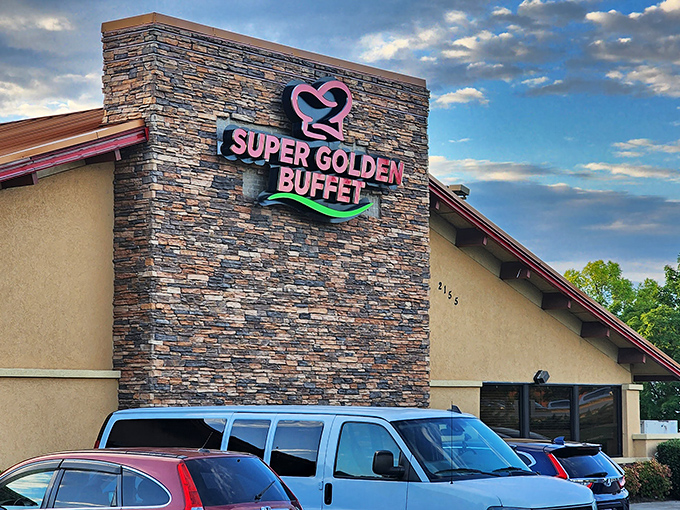 The stone facade of Super Golden Buffet beckons with its vibrant pink and green signage—like a neon promise of culinary abundance waiting inside.
