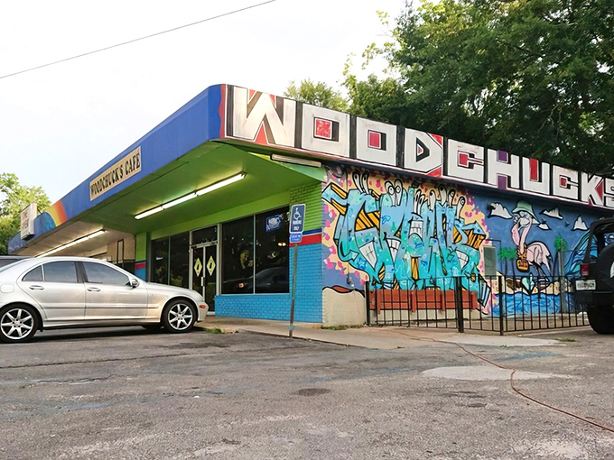 The vibrant blue and green exterior of Woodchuck's Cafe stands out like a tropical oasis in Tallahassee, complete with eye-catching mural that screams "we're not your average diner."