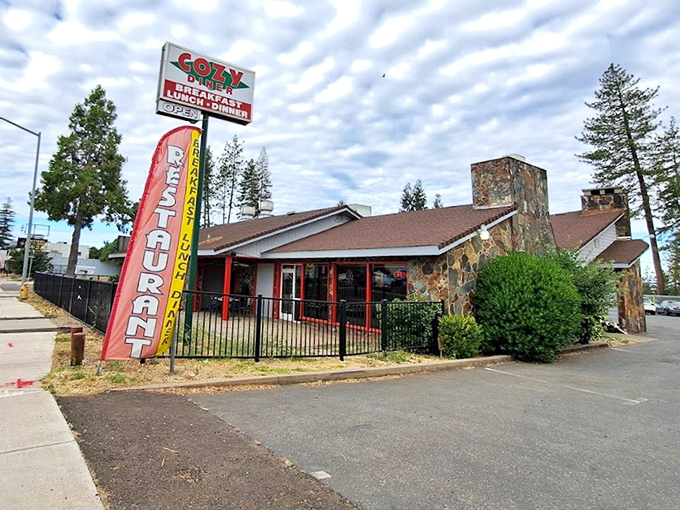 The stone facade and classic neon sign promise what every road trip deserves&mdash;a genuine diner experience where comfort trumps pretension.