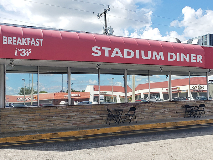The iconic red awning of Stadium Diner stands out like a beacon for hungry travelers. No fancy frills, just the promise of honest-to-goodness comfort food inside.
